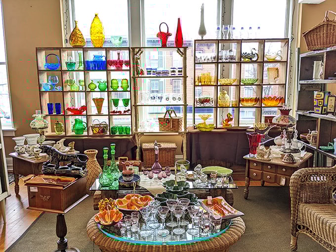 A rainbow of vintage glassware catches the light like edible jewels—each piece silently whispering stories of dinner parties and holiday gatherings past.