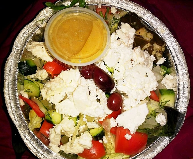A Greek salad that doesn't skimp on the feta—chunky, fresh, and vibrant enough to make you momentarily forget you came for the pie.