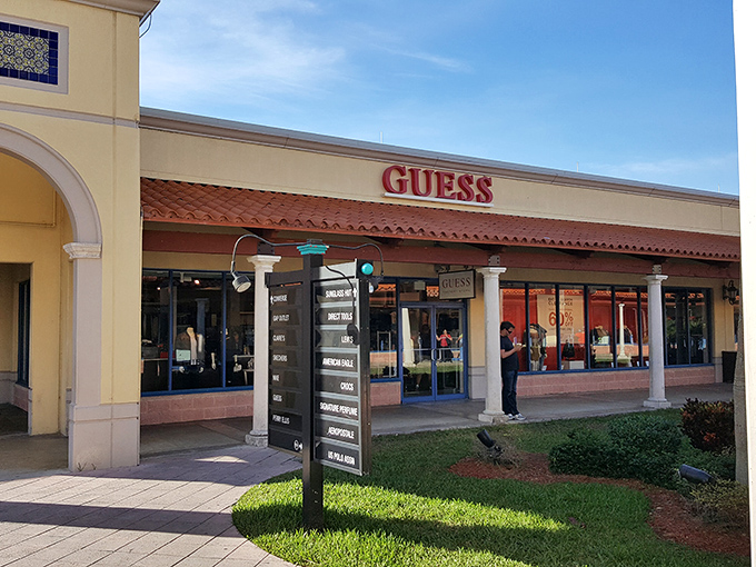 GUESS what store this is? The iconic brand's storefront blends seamlessly with the mall's Mediterranean aesthetic—fashion with a Florida twist.