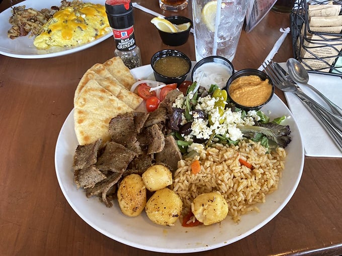 The gyro platter that transports you to Greece without the jetlag—seasoned meat, vibrant salad, and fluffy rice in perfect harmony.