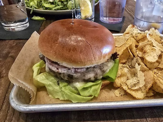 A burger that doesn't need gimmicks—just perfectly seasoned beef, fresh lettuce, and a bun that's achieved bread nirvana. Those house-made chips aren't messing around either.