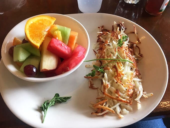 Fresh fruit bringing a pop of color and virtue to a plate of hash browns—nature's way of saying "balance is everything."