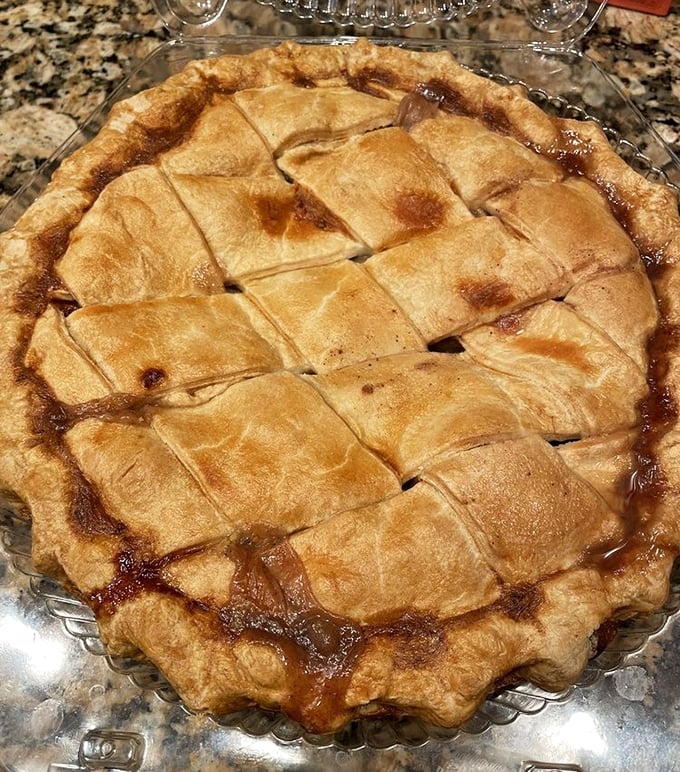 The lattice top on this apple pie isn't just showing off – it's providing a perfect window into caramelized fruit paradise. Grandma would approve.