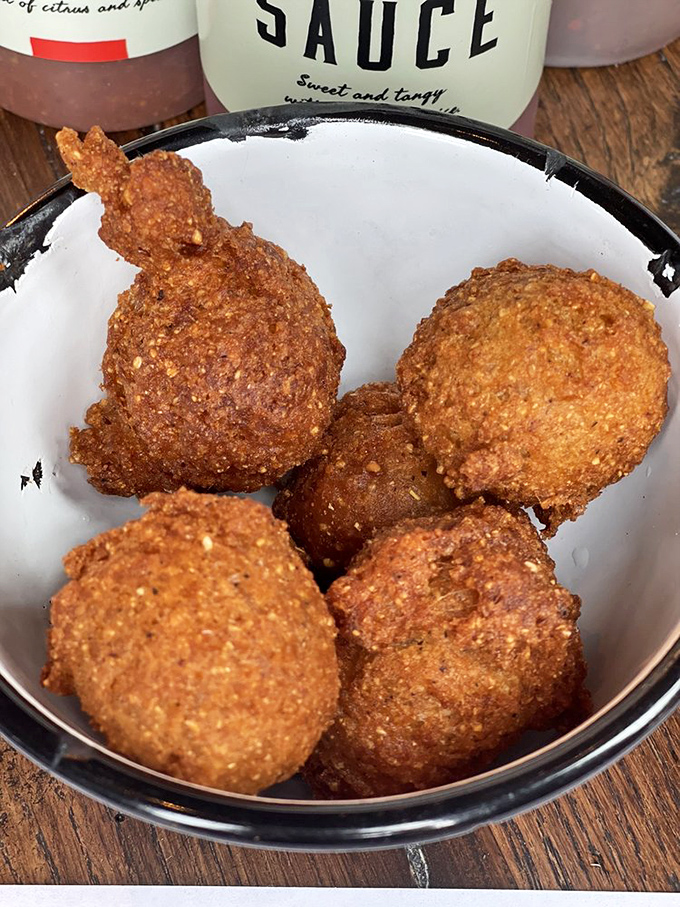 These hush puppies aren't just fried cornmeal—they're golden orbs of happiness with the perfect crisp-to-tender ratio that would make your grandmother jealous.