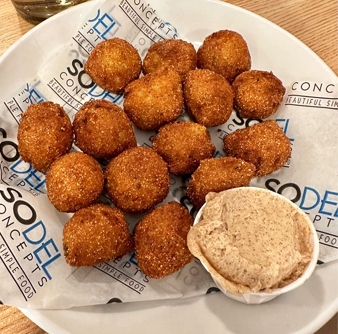 Hush puppies so perfectly golden they deserve their own trophy case—little orbs of cornmeal joy that whisper "you're welcome" with every bite.