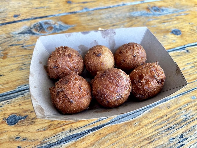 Hush puppies golden and crisp, waiting to silence your hunger. These little orbs of cornmeal joy are the unsung heroes of barbecue.