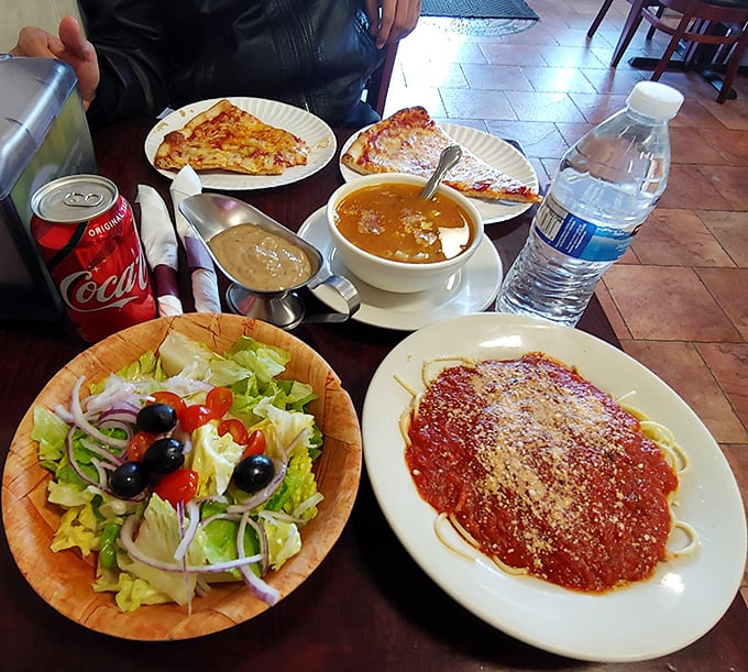 A feast for both eyes and stomach: garden-fresh salad, hearty soup, and pasta draped in vibrant marinara—the Italian trifecta of satisfaction.