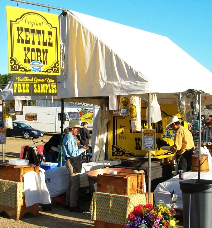 The kettle corn stand—where the sweet aroma of caramelizing sugar creates a temporary truce in even the most heated haggling.