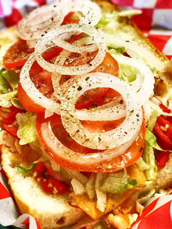 The hoagie that launched a thousand road trips. Fresh tomatoes, crisp lettuce, and thinly sliced onions create a garden of delights. 