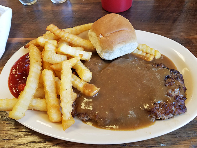 Hamburger steak swimming in gravy with a side of fries—comfort food that hugs your soul and whispers, "Everything's gonna be alright."