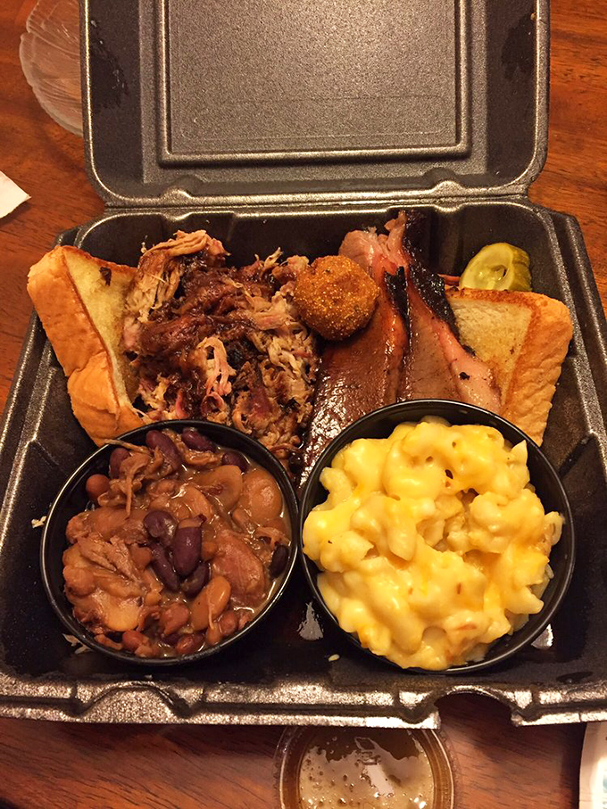 A BBQ plate that tells a story—smoky meat, beans with attitude, and mac and cheese so yellow it could direct traffic.