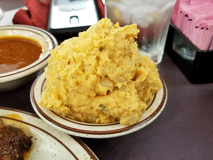 These mashed potatoes weren't just whipped – they were sweet-talked into creamy submission. Comfort food architecture at its finest.