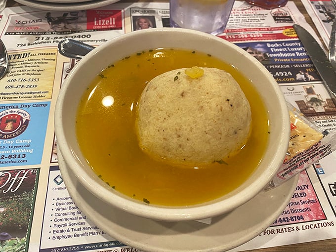 The matzo ball soup – a golden pool of comfort cradling what might be the fluffiest matzo ball this side of your grandmother's kitchen.
