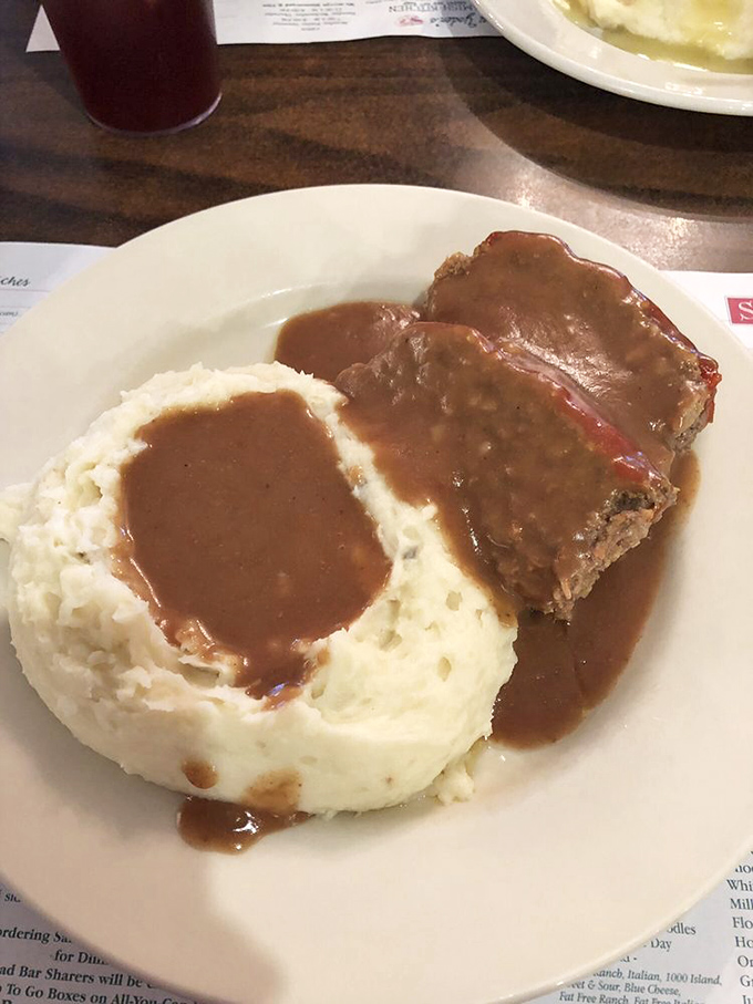 The meatloaf that launched a thousand food pilgrimages. Those mashed potatoes aren't just a side dish—they're the perfect gravy delivery system.