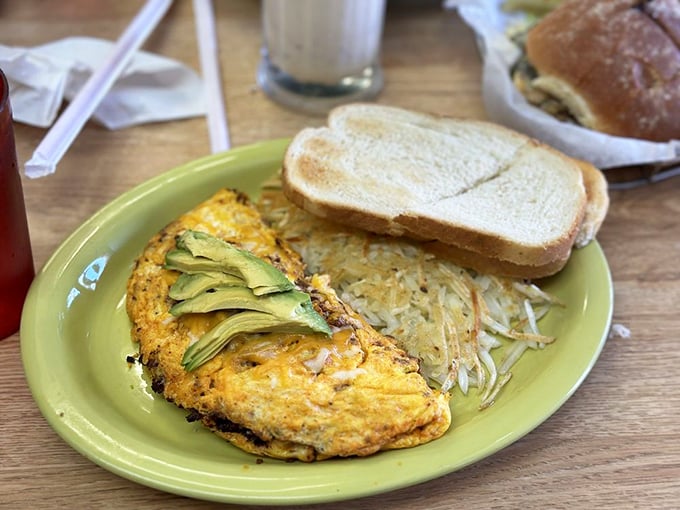 This isn't just breakfast—it's morning artwork. That avocado-topped omelet with crispy hash browns could cure even the most stubborn case of the Mondays.