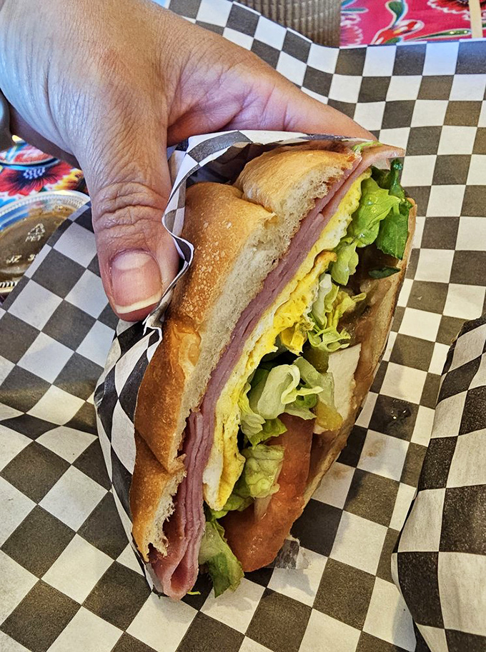 Not just a sandwich—a torta masterpiece where fresh bread, ham, and crisp vegetables come together in perfect structural integrity.