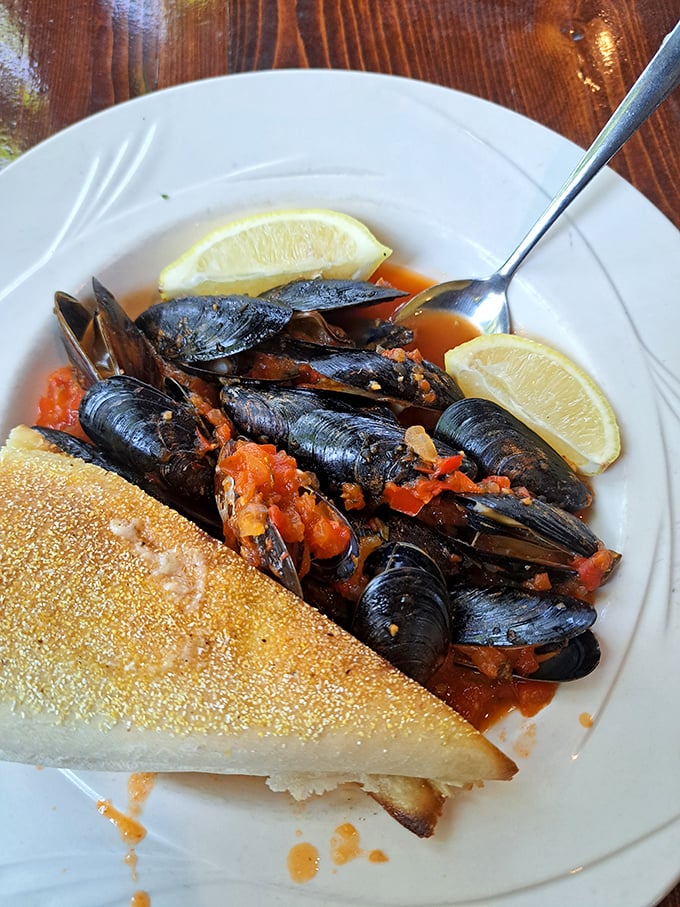 These mussels aren't just dinner; they're tiny ocean treasures bathed in a tomato broth worth sopping up with every available carb.