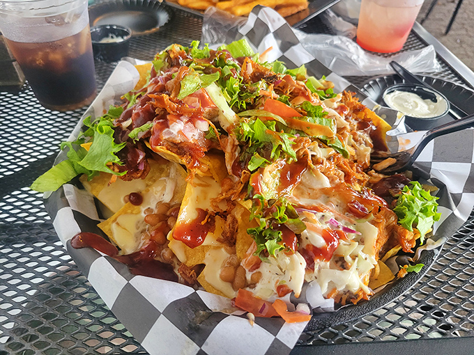 These loaded nachos aren't messing around—a mountain of toppings that requires strategic eating and possibly a plan of attack before diving in.
