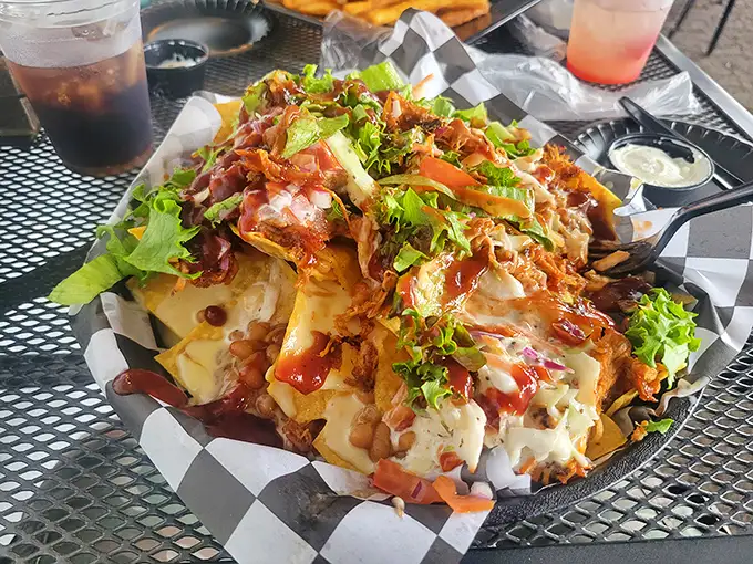 These loaded nachos aren't messing around—a mountain of toppings that requires strategic eating and possibly a plan of attack before diving in.