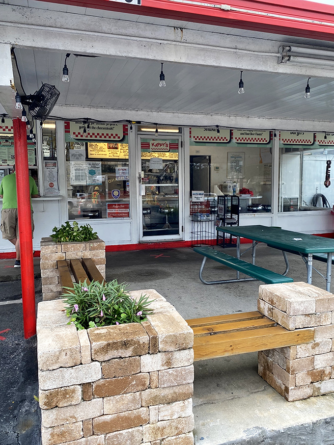 The outdoor seating area—where brick planters and picnic tables create the perfect stage for the main event: the food.