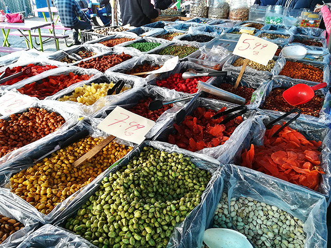 A kaleidoscope of nuts, dried fruits, and snacks creates a sensory explosion—like traveling the Silk Road without leaving Oakland.