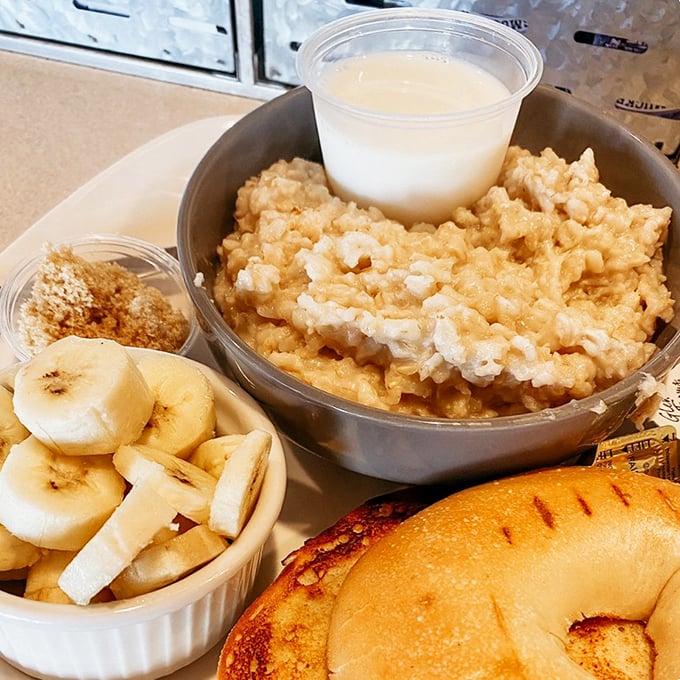 Oatmeal gets the VIP treatment with fresh banana slices and what appears to be a bagel that's been kissed by the perfect toasting gods.