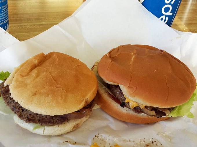Two classic burgers, side by side like an old married couple. No arguments here—just perfectly grilled patties and fresh toppings.