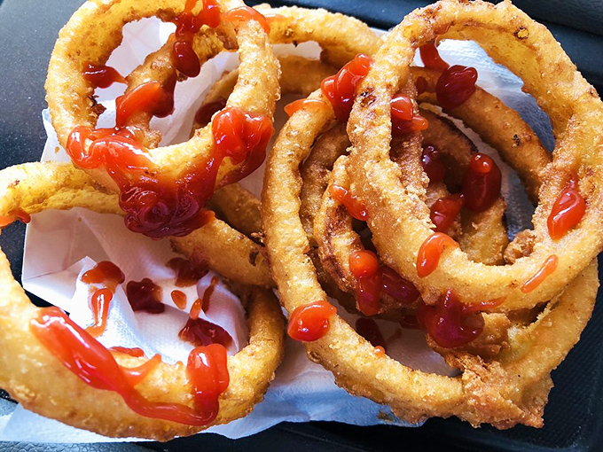These onion rings—golden, crispy halos of deliciousness—are why people willingly drive across county lines on a Tuesday afternoon.