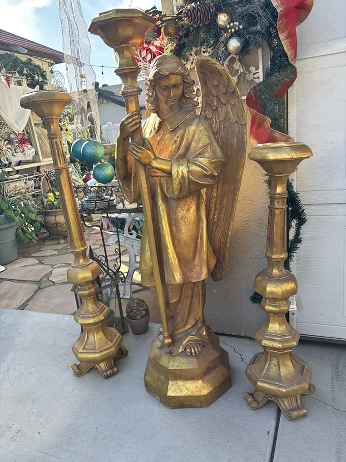 Not your average yard decoration! This golden guardian angel statue could transform a garden into a divine sanctuary or star in a Wes Anderson film.