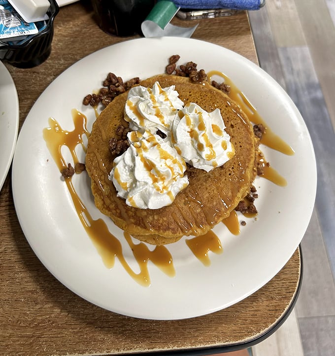 These pancakes don't just sit on the plate – they perform, topped with a cloud of whipped cream and caramel drizzle that makes maple syrup jealous.