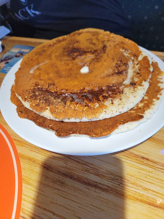 Pancakes that look like they've been working out—impressively large, golden-brown, and ready to soak up maple syrup like they're training for it.