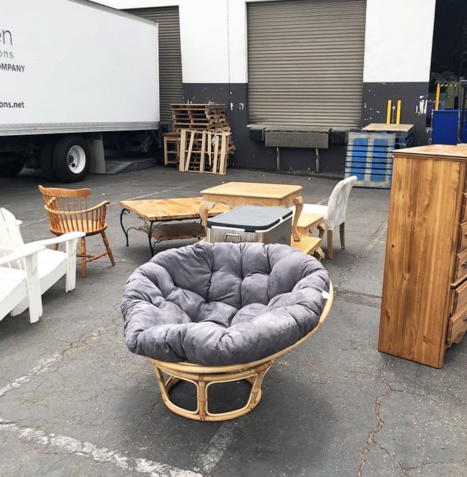 The papasan chair—that iconic '70s comfort pod—holds court among an eclectic assortment of furniture awaiting adoption. Instant dorm room upgrade, anyone?