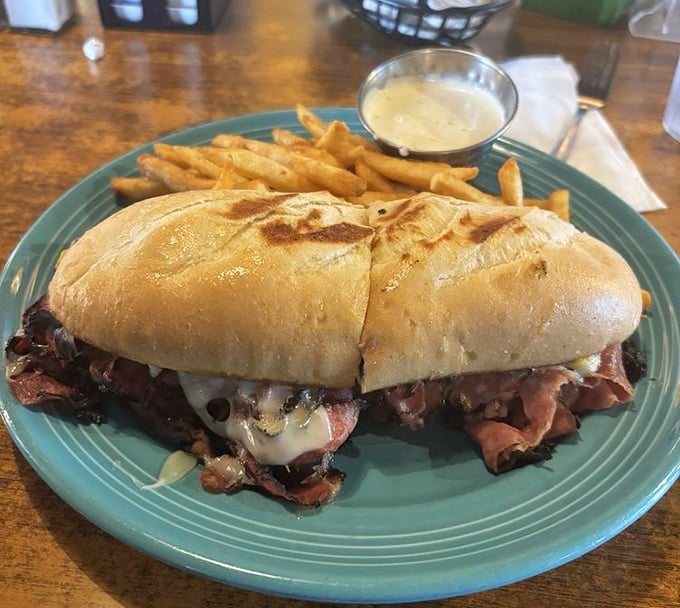 The pastrami sandwich—where meat and melted cheese perform a duet so beautiful you might forget to take a picture first.