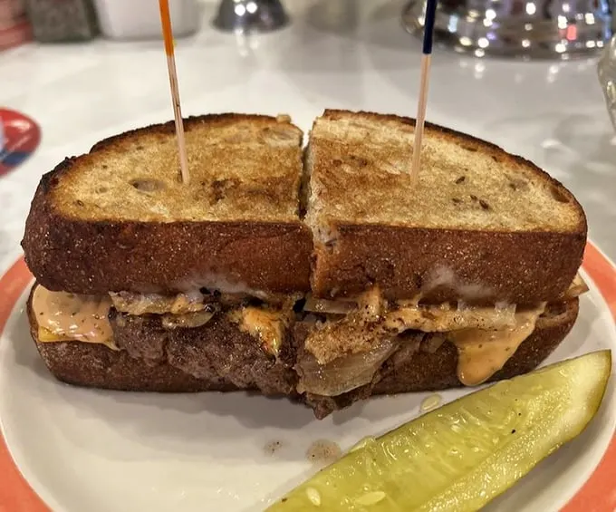Behold the patty melt in its melty, caramelized glory. This sandwich doesn't just satisfy hunger—it creates memories between two perfectly grilled slices.