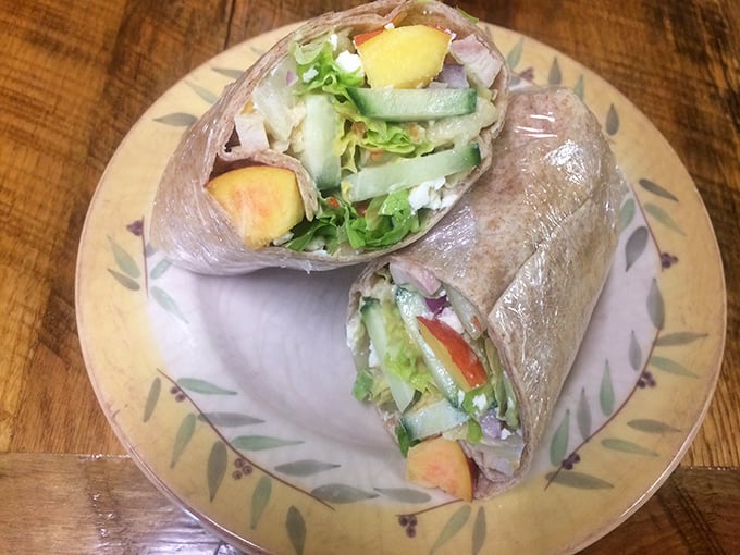 The Peach Wrap in its natural habitat—fresh ingredients nestled together like old friends at a reunion, ready to make your taste buds join the party.