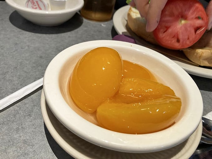 These glistening peaches aren't just fruit—they're little orbs of sunshine that brighten even the grayest Pennsylvania morning.