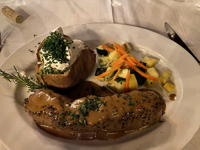 When your steak comes with its own silky sauce pool and a baked potato standing by, you know you're in for a proper feast.