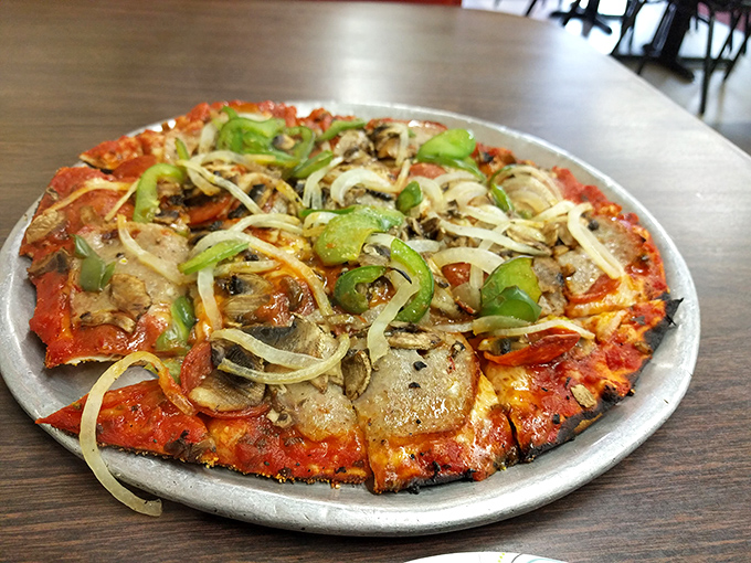 A symphony of toppings on a canvas of perfect crust. This isn't just pizza—it's edible art with mushrooms playing the lead role.
