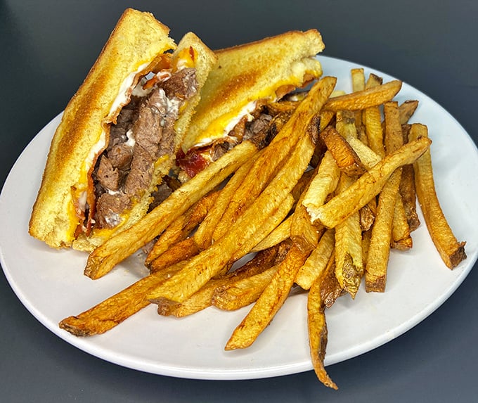 The Philly melt doesn't just cross state lines; it creates a borderless utopia where melted cheese unites perfectly toasted bread and tender steak.