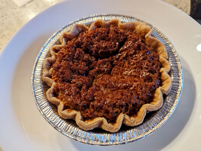 Buttermilk pie in its humble aluminum vessel. Don't let appearances fool you—this southern-inspired dessert delivers the perfect sweet finale.