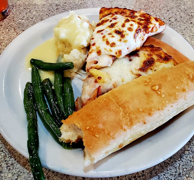 Pizza, mashed potatoes, green beans, and garlic bread – the Mount Rushmore of comfort food assembled on one glorious plate.