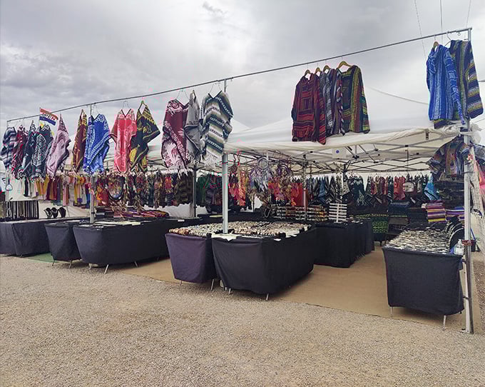 These aren't your college dorm ponchos—vibrant, handcrafted garments transform the desert marketplace into a textile rainbow.