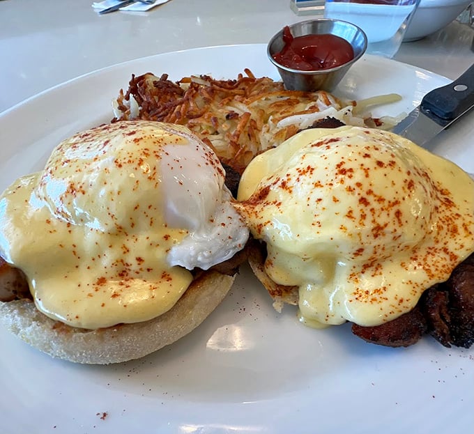 Eggs Benedict done right—with hollandaise sauce cascading like a golden waterfall. The crispy hash browns are the supporting actor who steals the scene.
