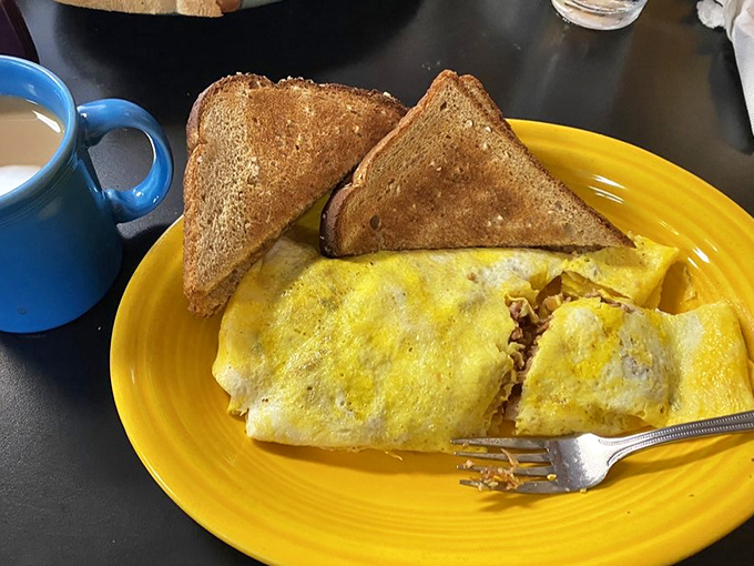 This omelet doesn't just contain pulled pork – it showcases it like a headliner at a culinary concert, with perfectly toasted bread as the opening act.