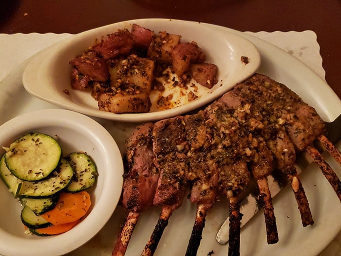 The rack of lamb stands at attention, seasoned to perfection and ready for its close-up. Those potatoes and veggies aren't just sidekicks—they're co-stars.