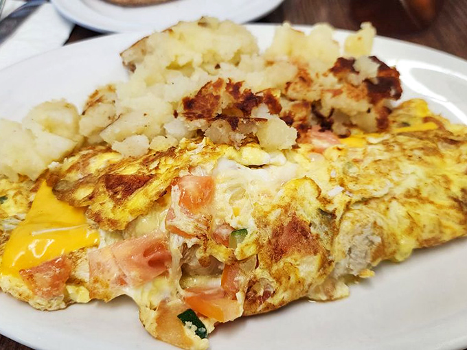 An omelet that's not playing games—packed with enough fillings to make you wonder how they managed to fold it without supernatural assistance.