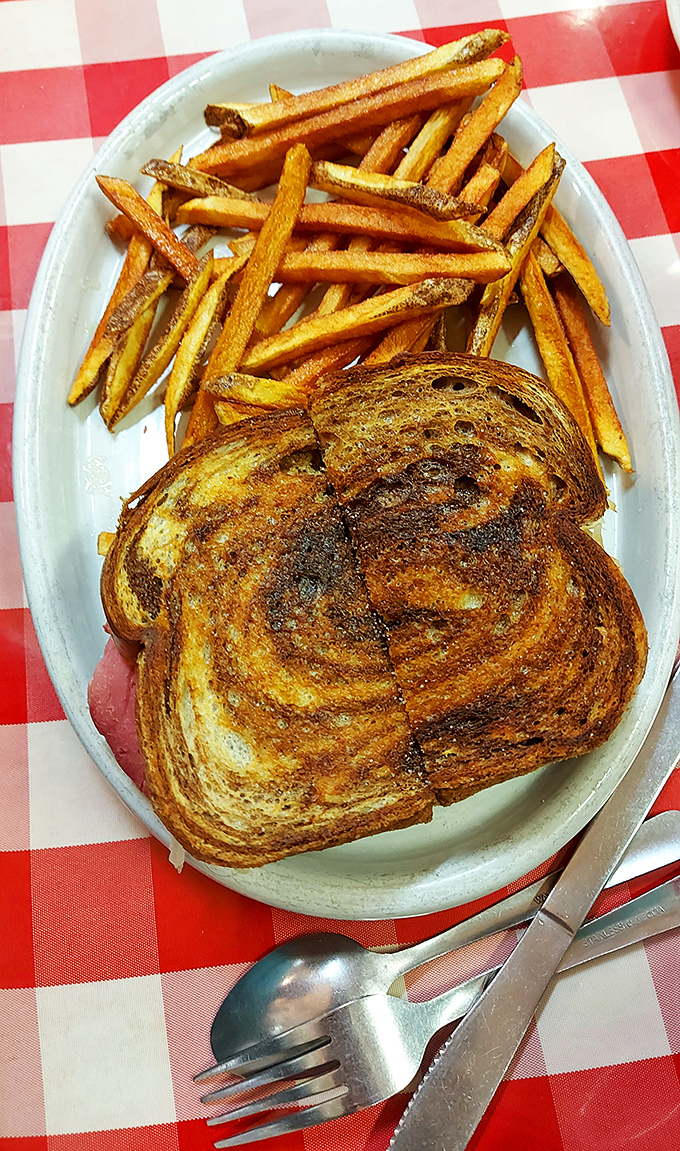 Golden-brown perfection meets crispy potato companions. This grilled sandwich and fries duo could make even a food photographer weep with joy.