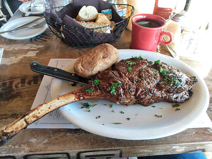 A ribeye steak with the kind of char that makes grill masters weep with joy, served with a baked potato that's practically begging to be devoured.
