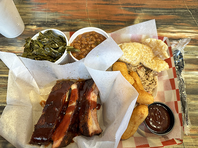 A barbecue tray that hits all the right notes—smoky ribs, tender collards, and beans that have clearly been simmering since breakfast.