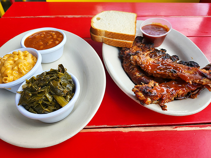 The holy trinity of Southern comfort: mac and cheese, collard greens, and ribs that make you forget table manners exist.